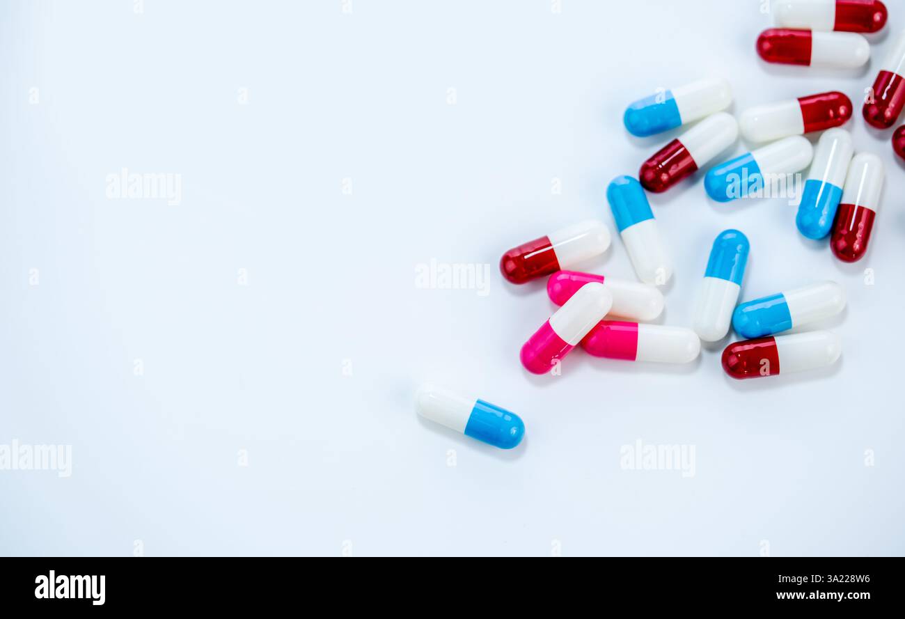 Colorful capsules arranged on a white surface. Pharmaceutical ...