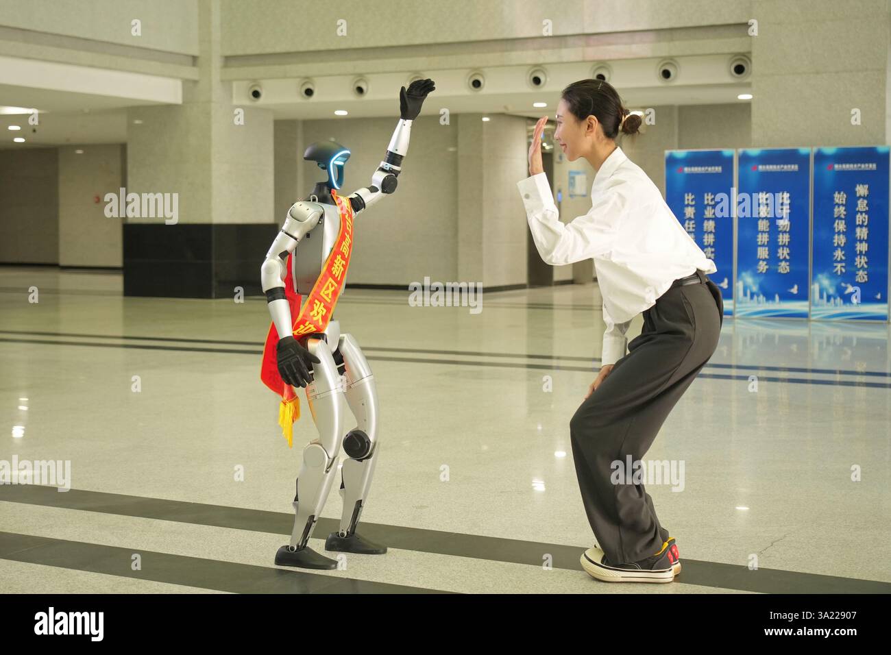 YANTAI, CHINA - MARCH 11, 2025 - A Unitree G1 humanoid robot greets ...