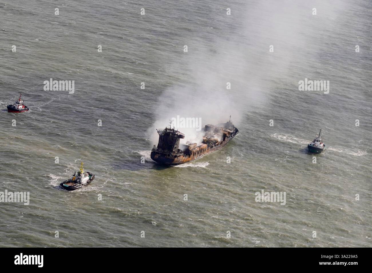 Tug boats shadow the Solong container ship as it drifts in the Humber ...