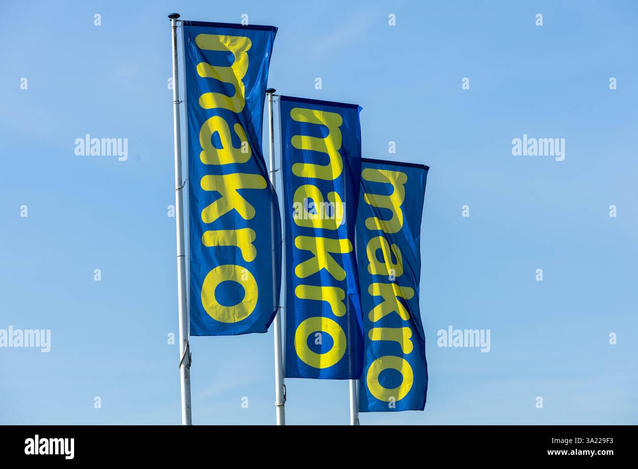 Makro logo on three flags. Makro is a Dutch international brand of ...