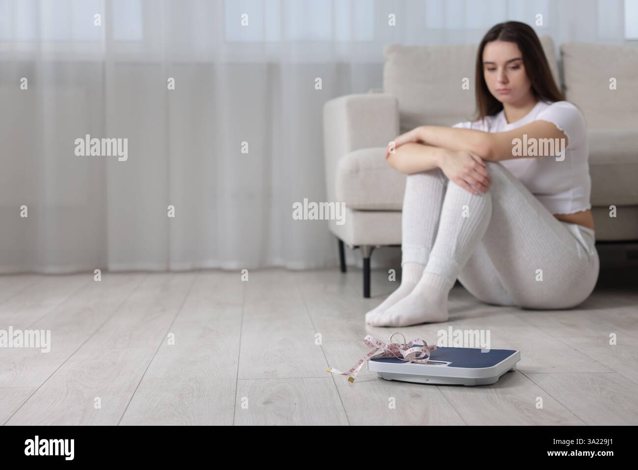 Depressed woman scales measuring hi-res stock photography and images ...