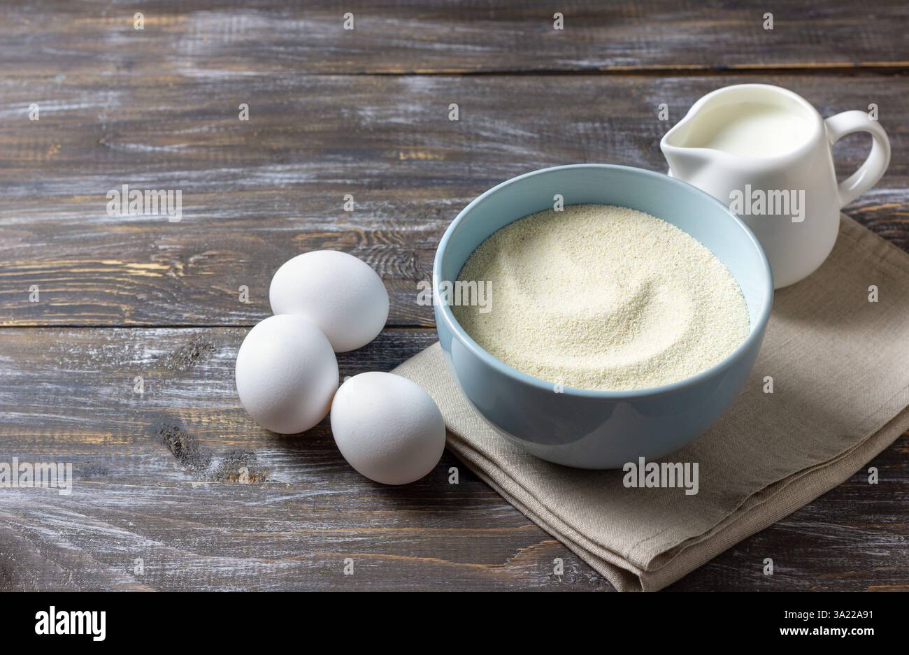 Cooking ingredients featuring a blue ceramic bowl filled with semolina ...