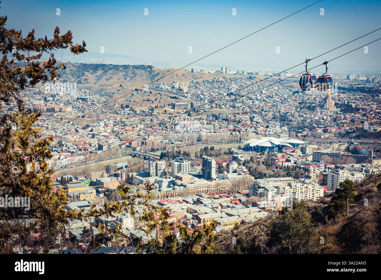 Scenic aerial view of Tbilisi, Georgia, with a modern cable car gliding ...
