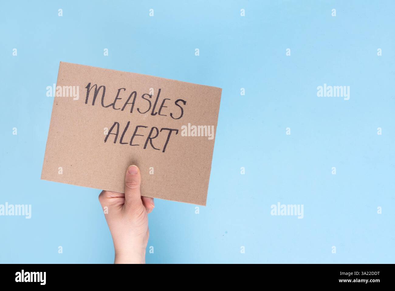 Text Measles alert, quarantine on paper banner in woman hand. Female ...