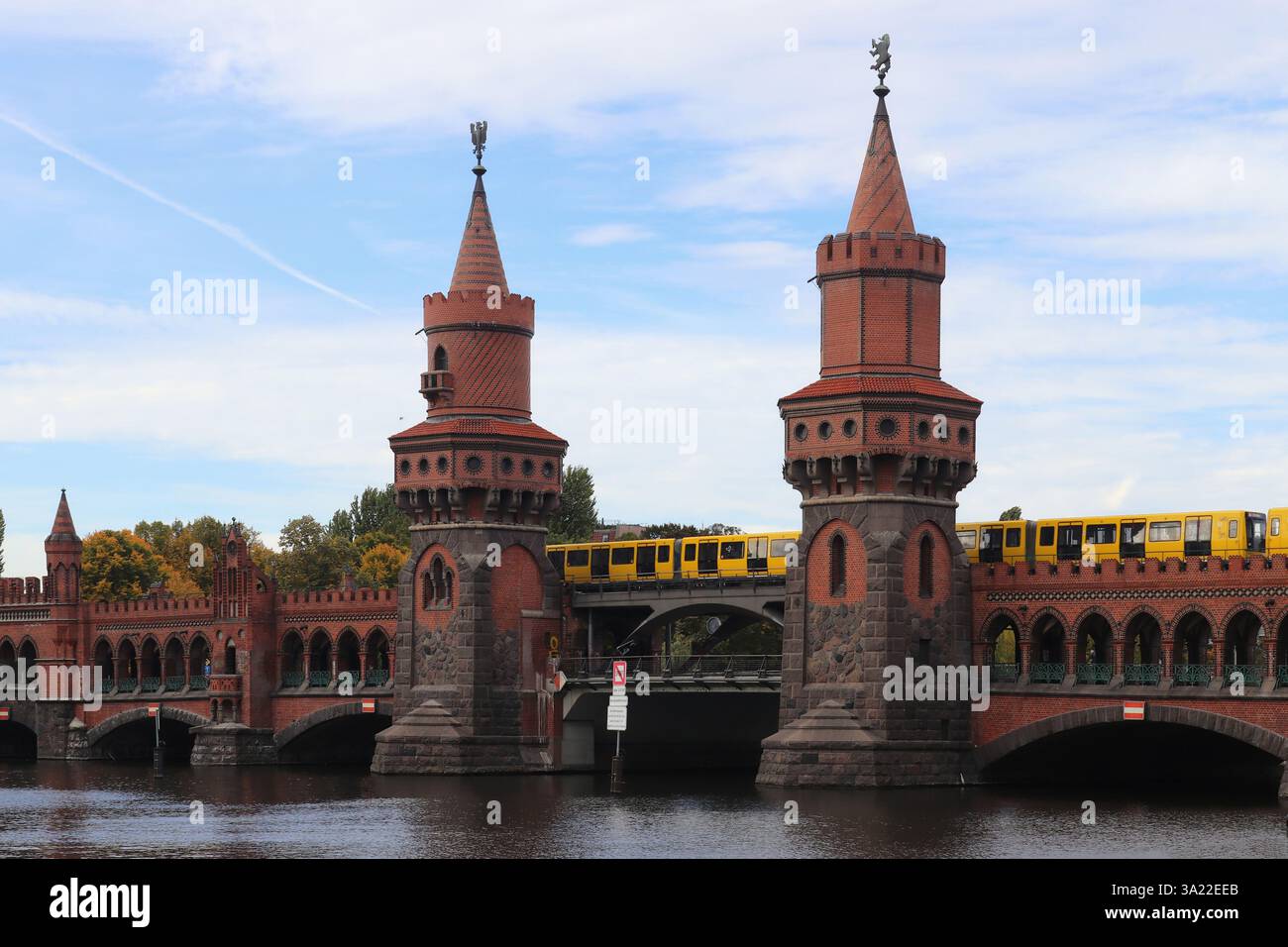 Berlin, Germany 03. October 2024, Yellow train crossing the Oberbaum ...