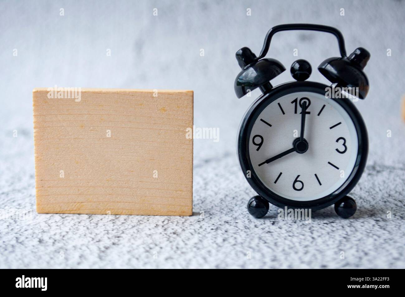 Empty wooden banner with alarm clock pointing at 8 PM or 8 AM. Time and ...