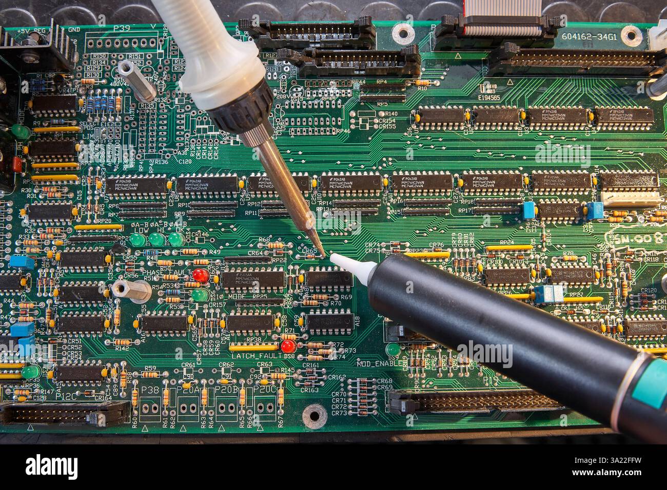 Electronics Repair Scene Featuring Circuit Board and Soldering Process ...