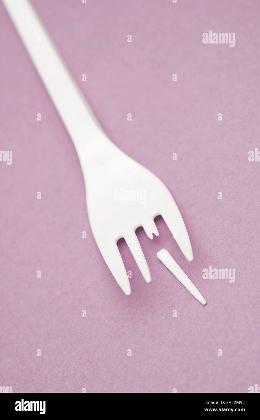 white plastic fork with one broken tine Stock Photo - Alamy