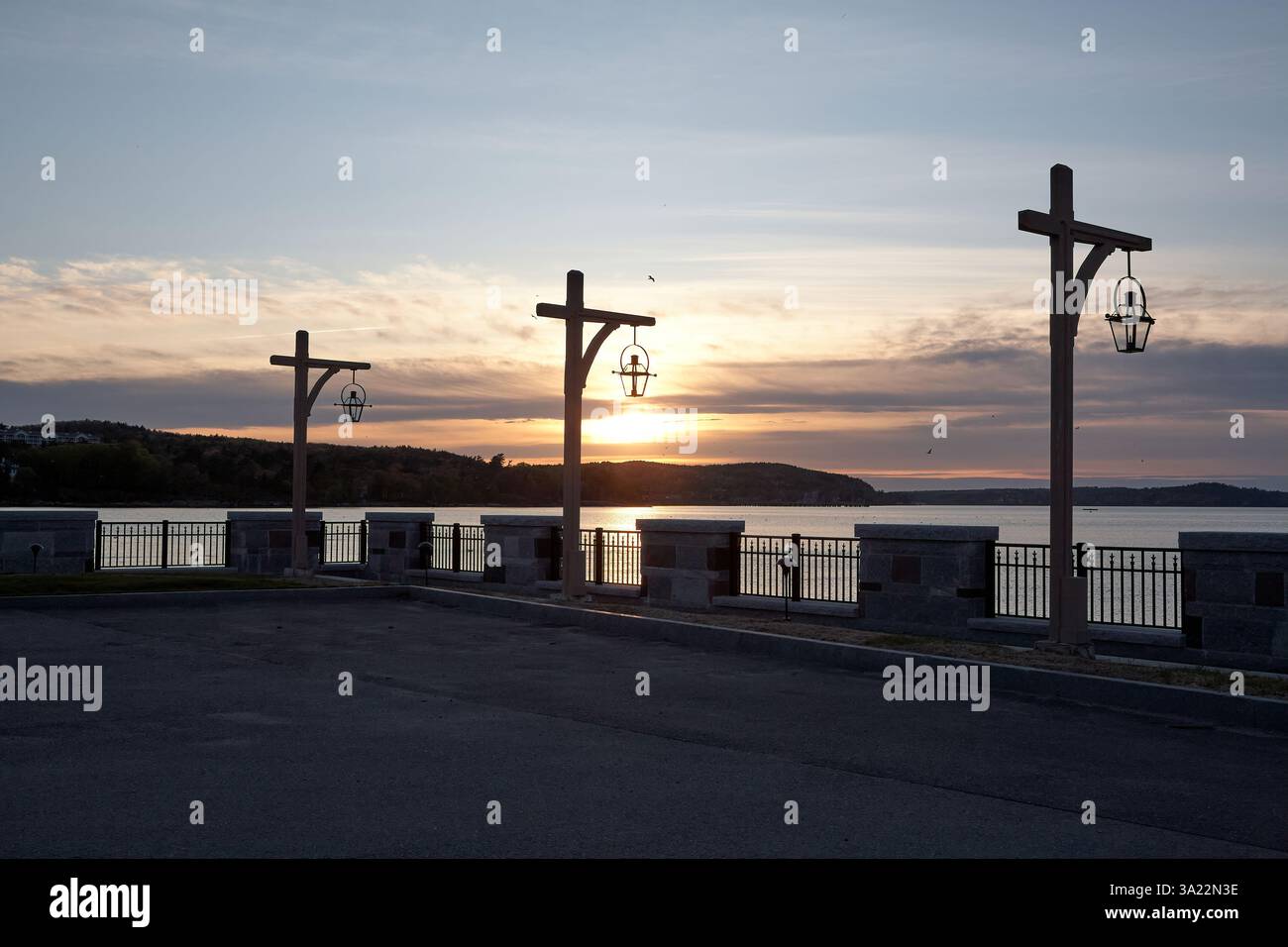 Sunset with lamp post and fencing Stock Photo - Alamy