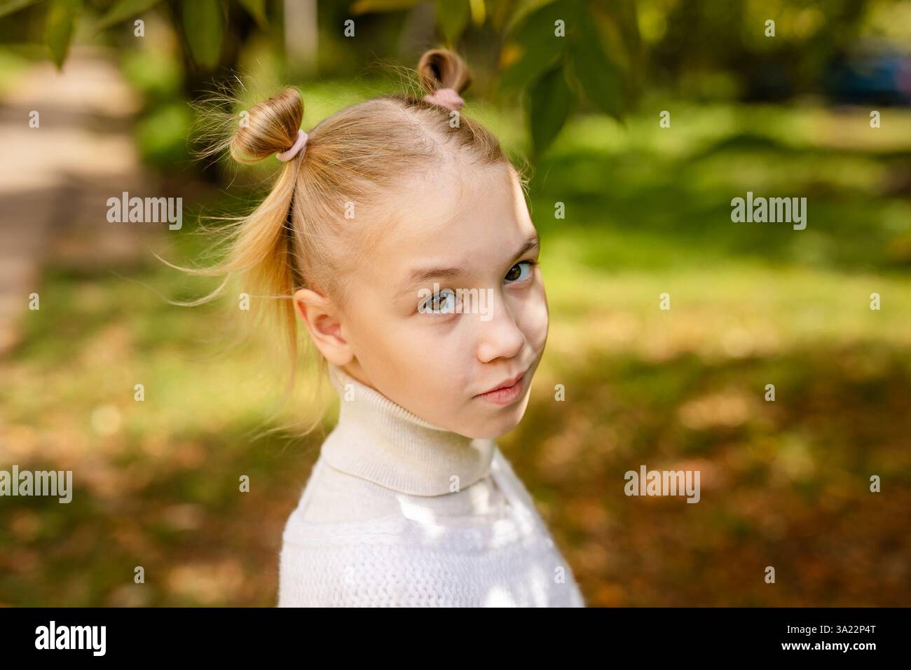 Portrait of a blonde girl with brown eyes and two ponytails Stock Photo ...