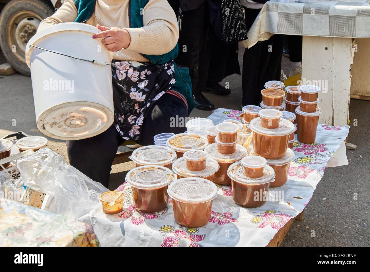Street vendors sell festive dish sumalak in plastic containers, Nowruz ...