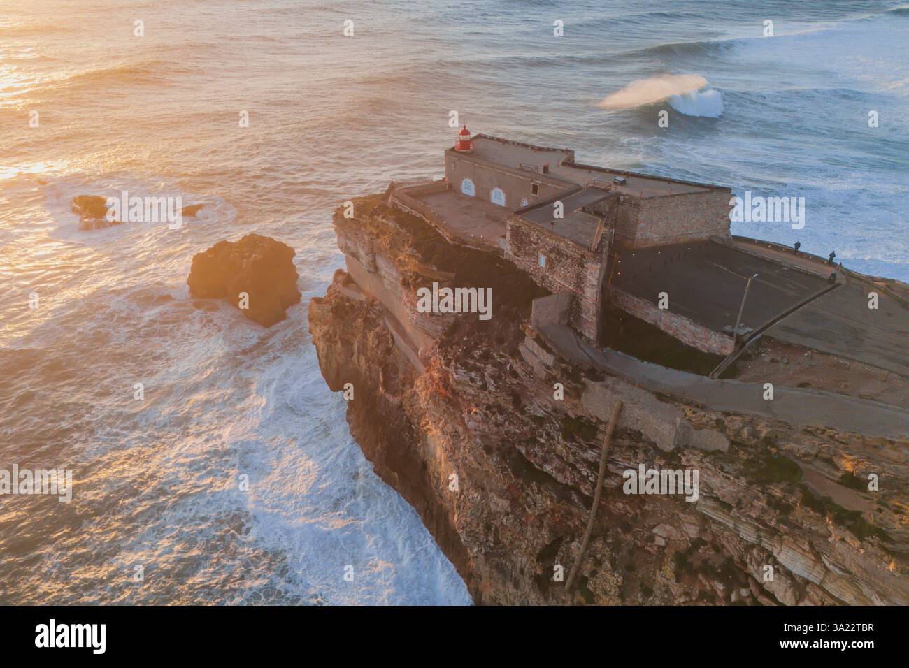 Aerial view of the The Nazare Lighthouse - Farol de Nazare - at sunset ...