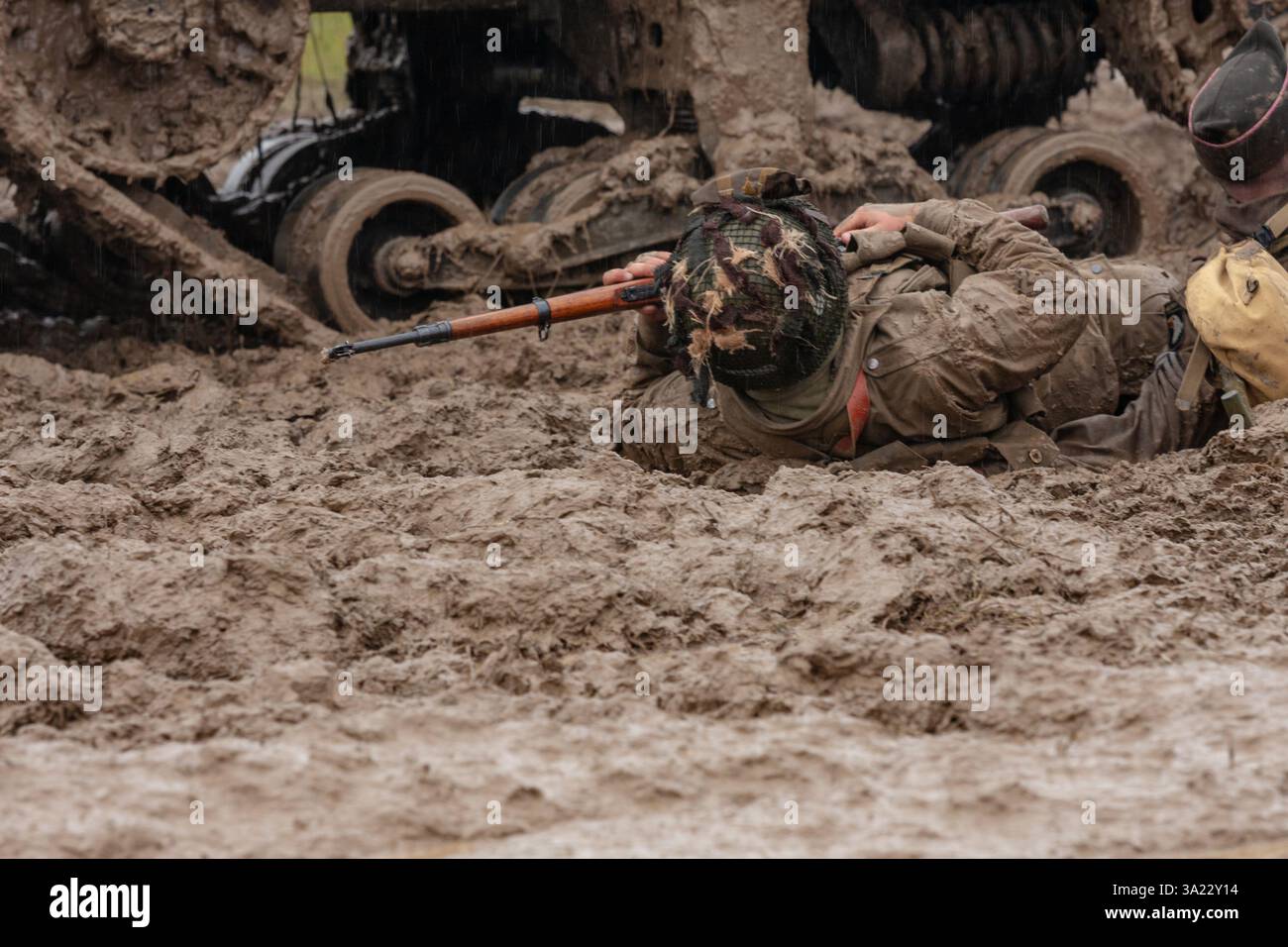 World War II battle reenactment. An American paratroop army soldier ...