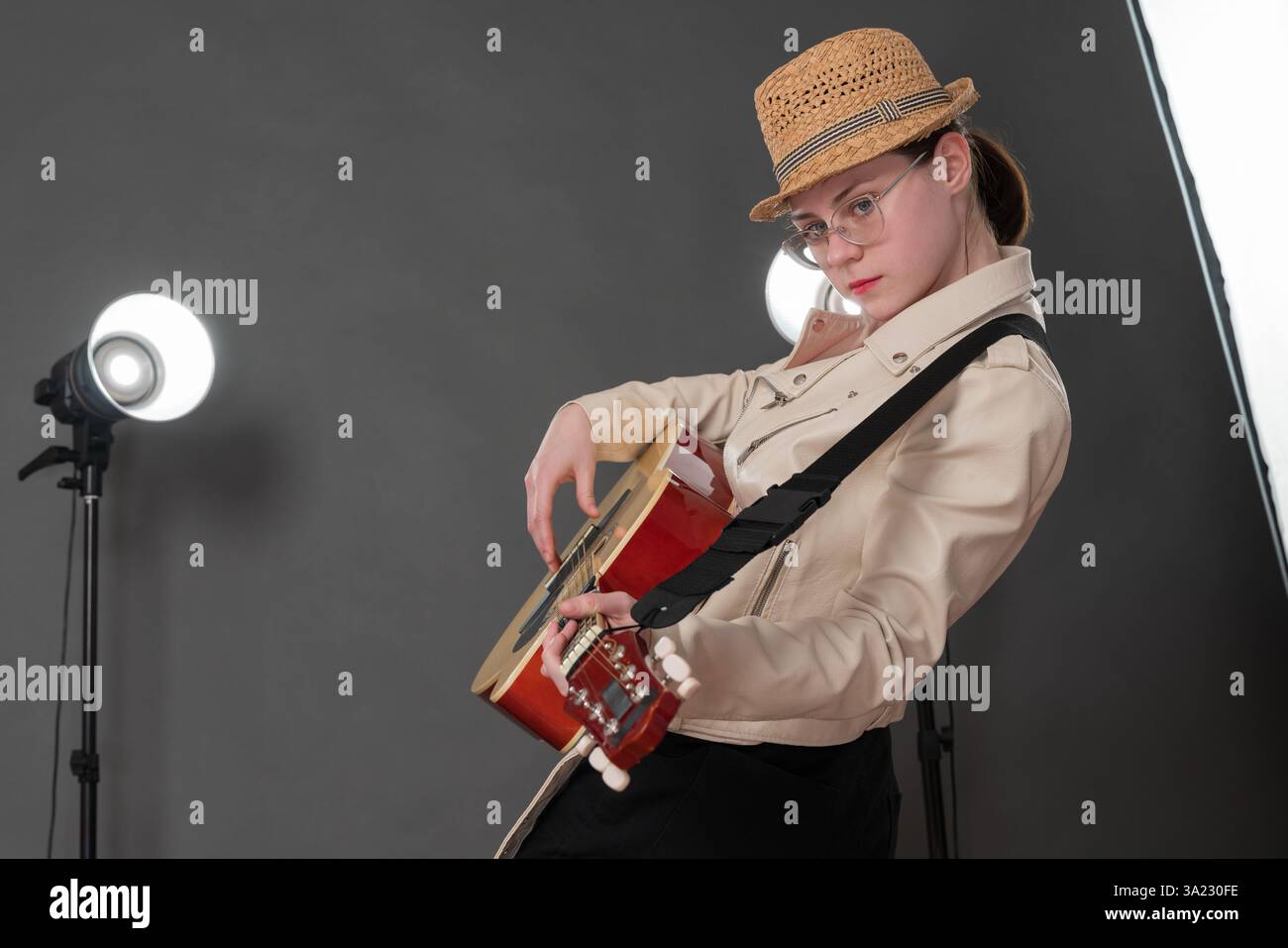 Side view of beautiful female guitarist, strumming her Spanish six ...