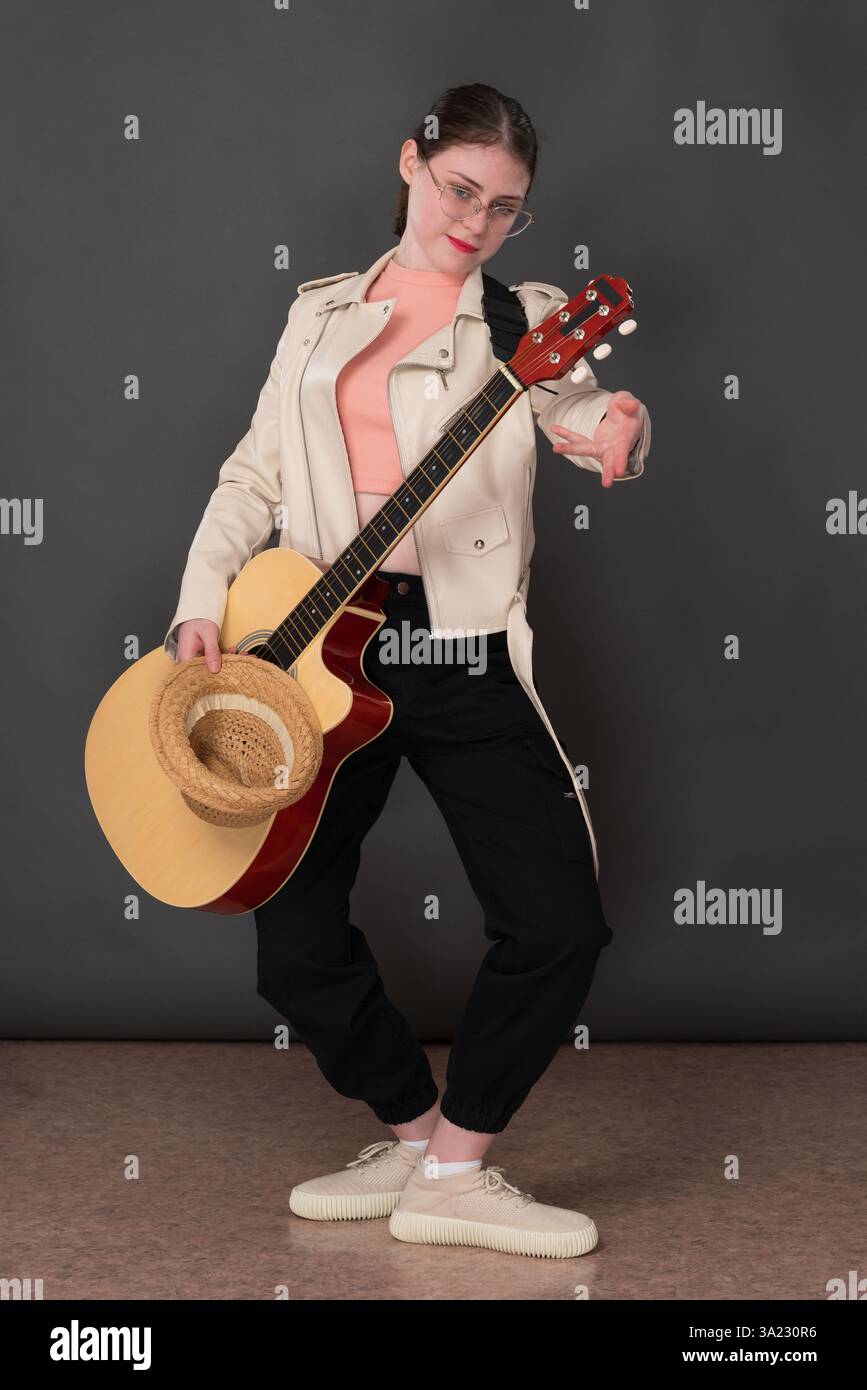 Female guitarist with classical guitar in plie position like ballerina ...