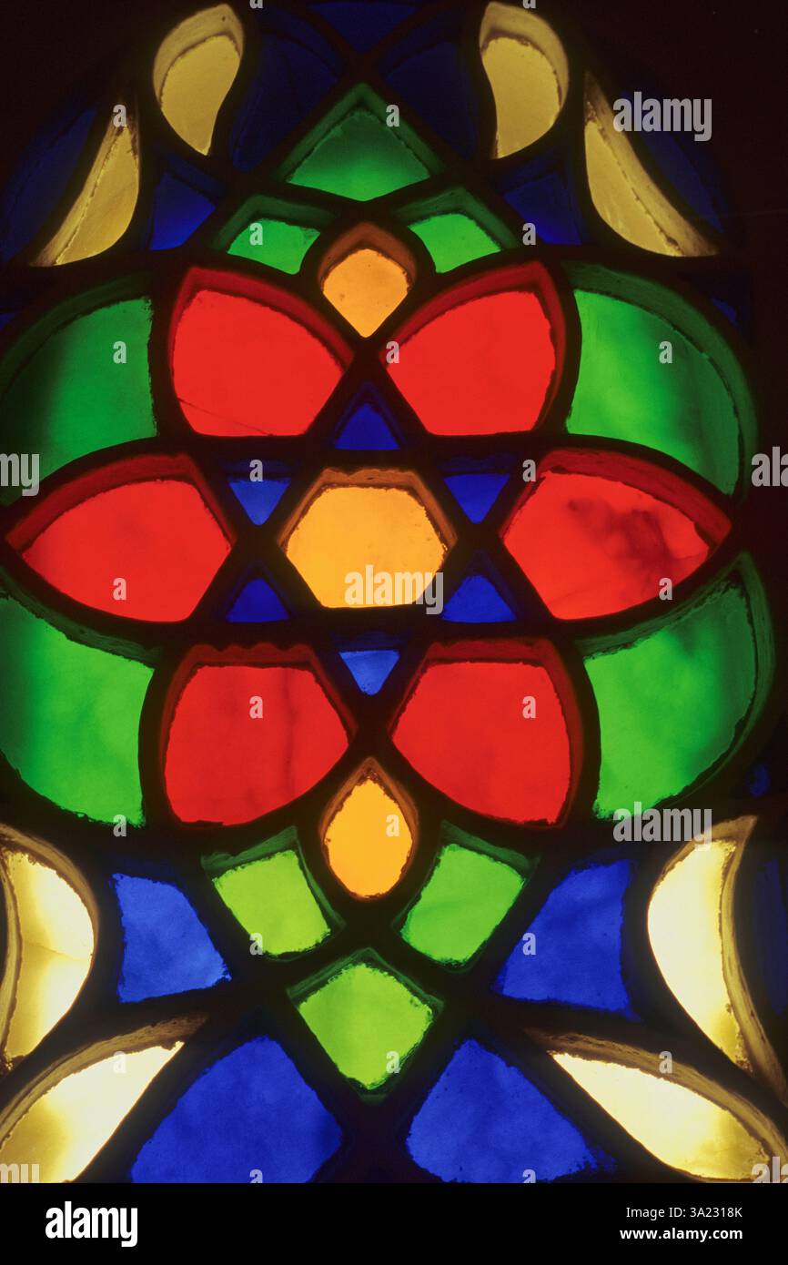 Detail of geometric Yemeni stained glass in red, green, blue, orange ...