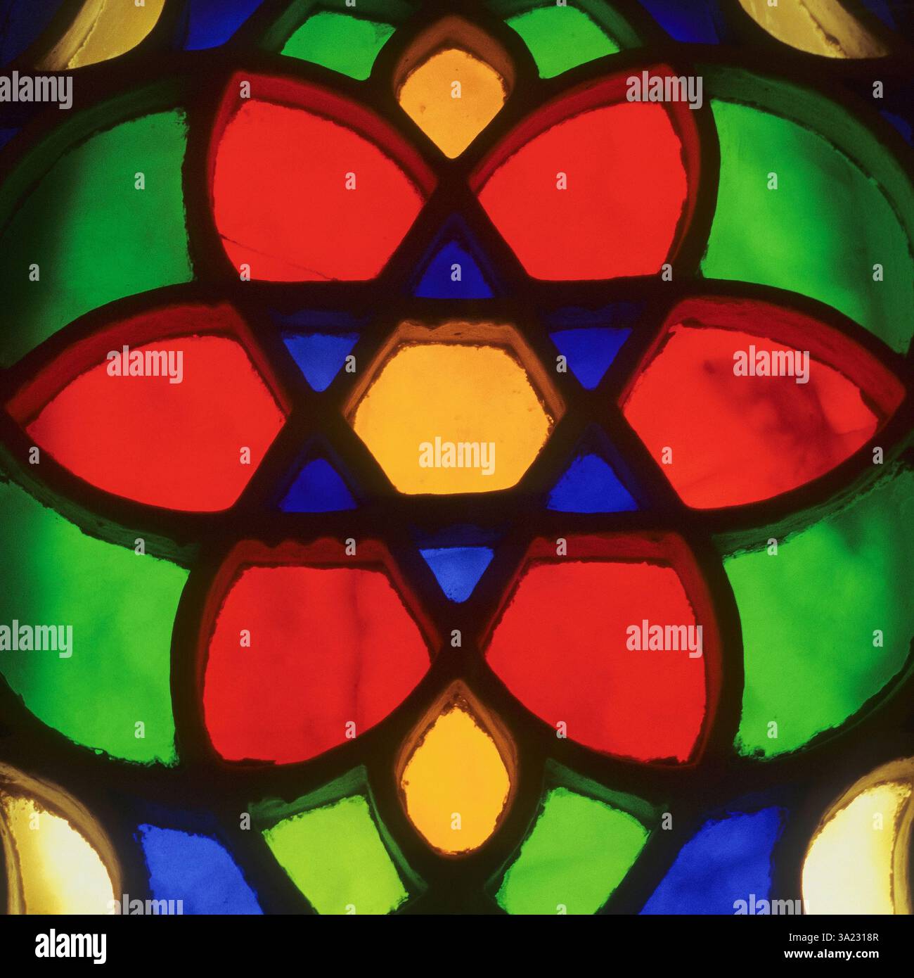 Close detail of geometric Yemeni stained glass in red, green, blue ...