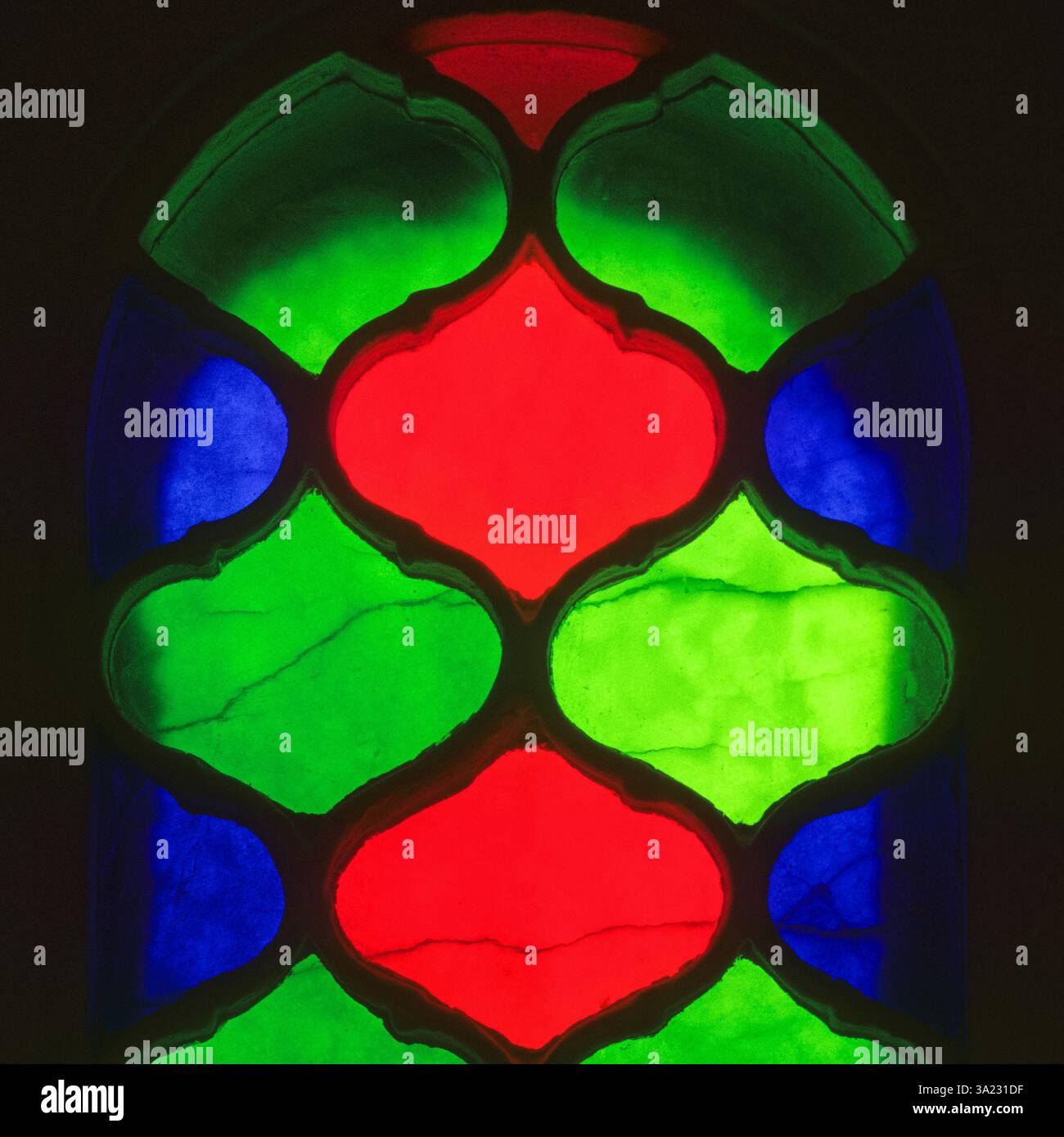 Curved stained glass shapes in red, blue and green within the takhrim ...