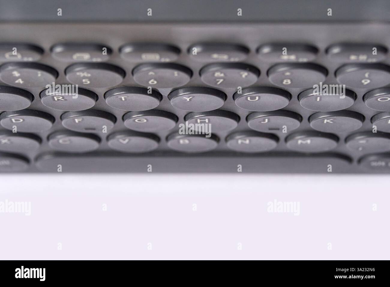 Close up of black retro style circular keyboard with round keys and ...