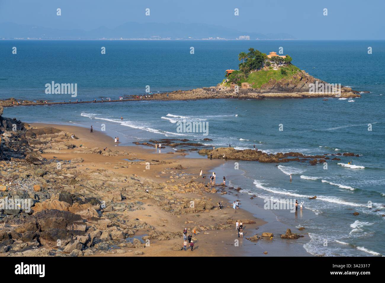 This is a view of the beach shore and Hon Ba Temple Island, a famous ...