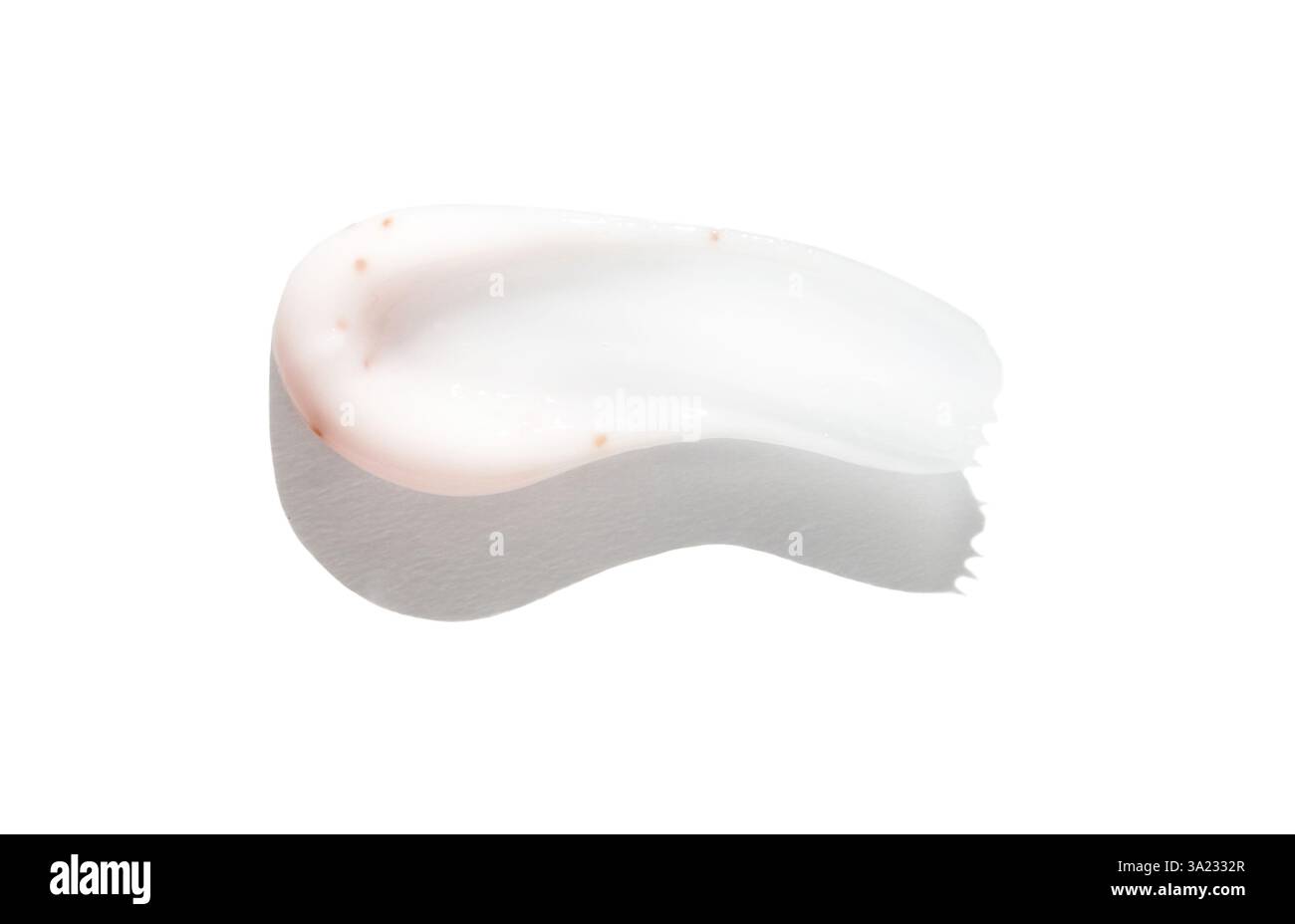 White cream smear on white background with shadow highlighting texture ...