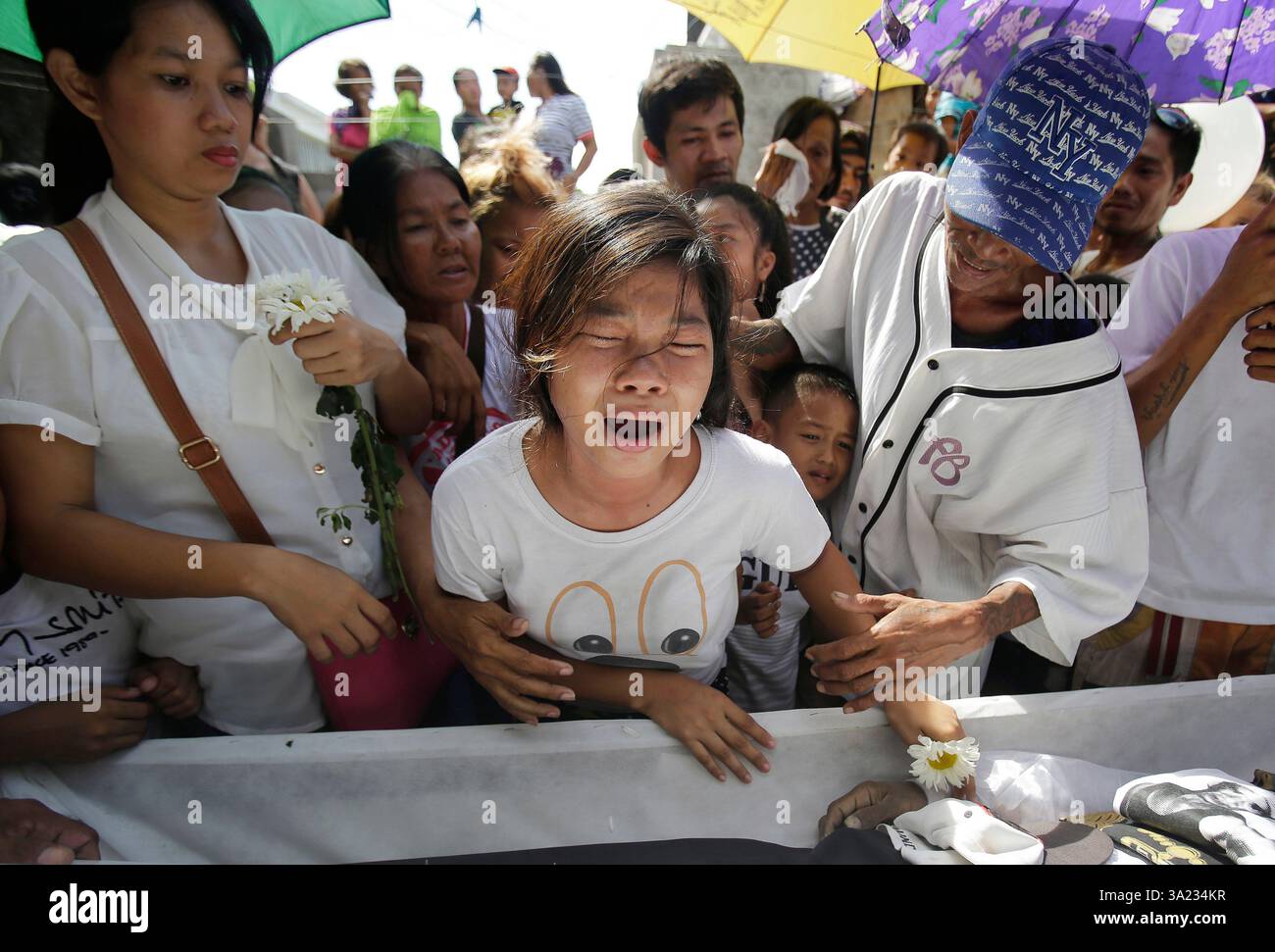 FILE - Family and friends grieve as they pay their last respects to ...