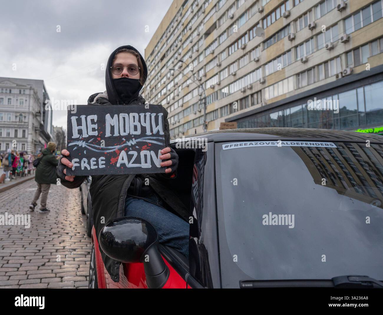 Kyiv, Ukraine - 2d, February, 2025: Young man sitting on car windowsill ...