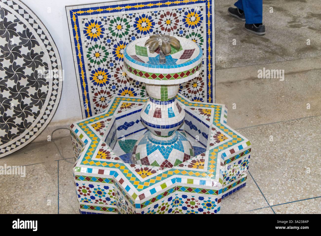A moroccan pottery maker creates ceramics in a workshop in old medina ...