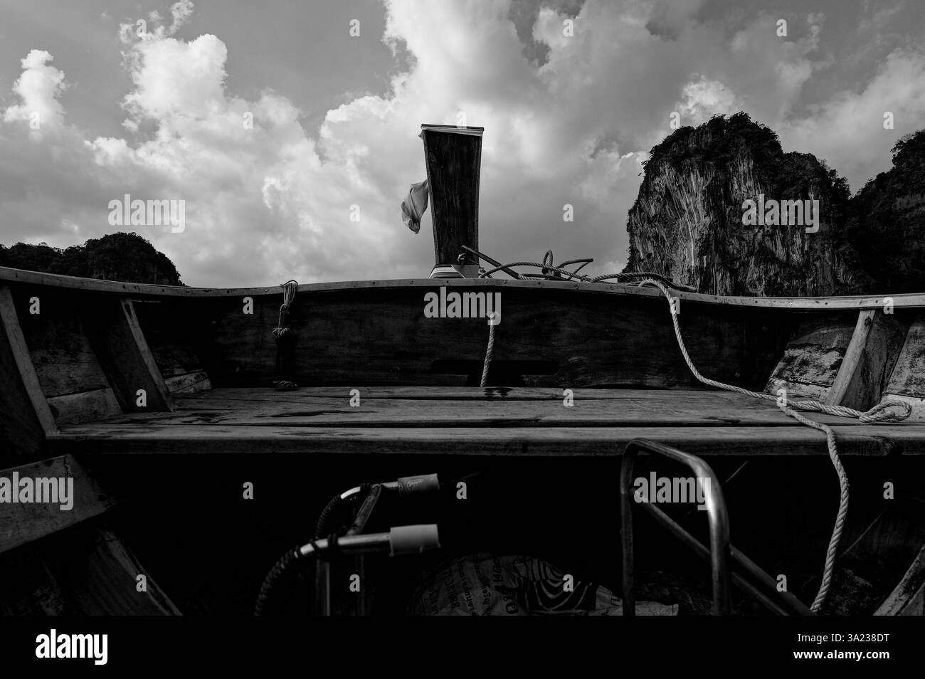 A traditional wooden longtail boat with its rustic interior, framed by ...