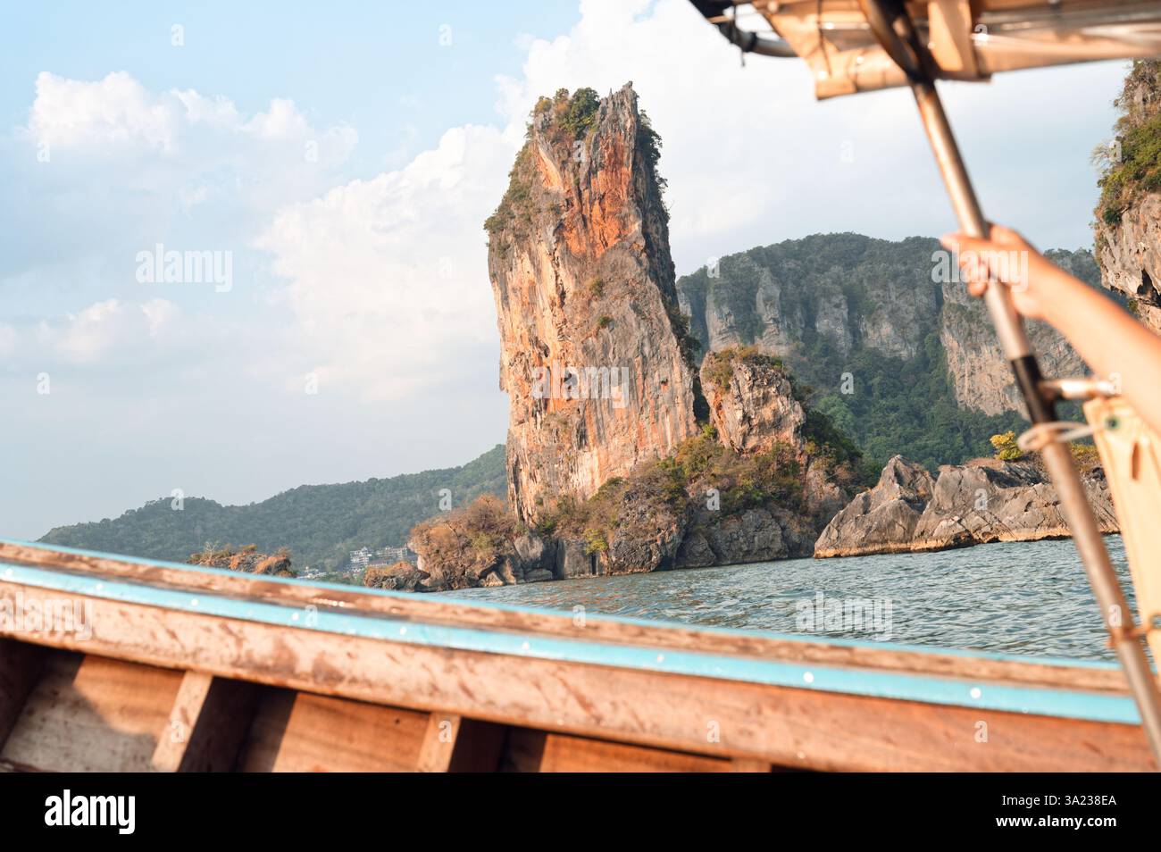 Longtail boat glides across serene hi-res stock photography and images ...