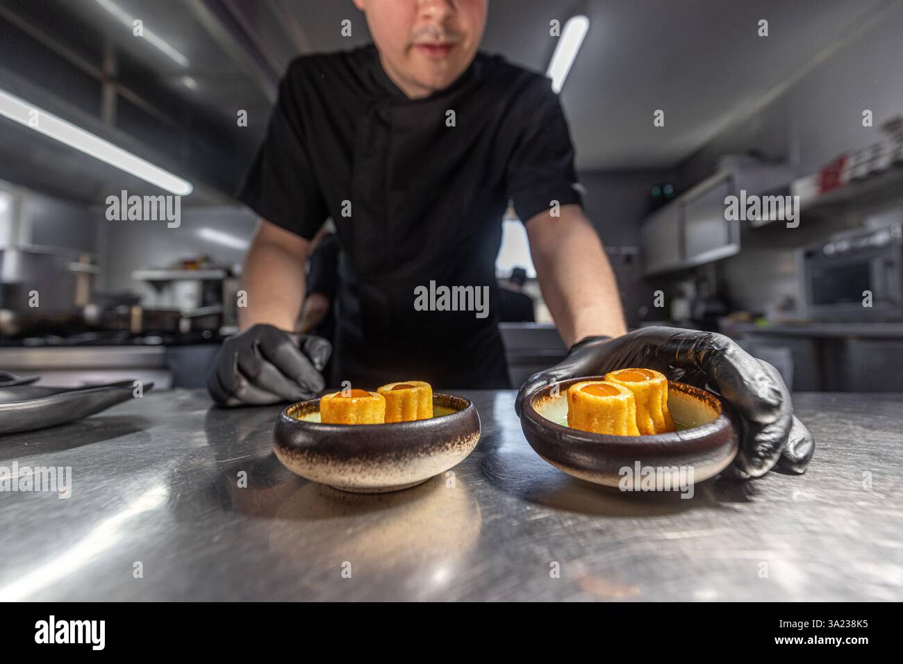 Chef finishing gourmet appetizers in restaurant kitchen Stock Photo - Alamy