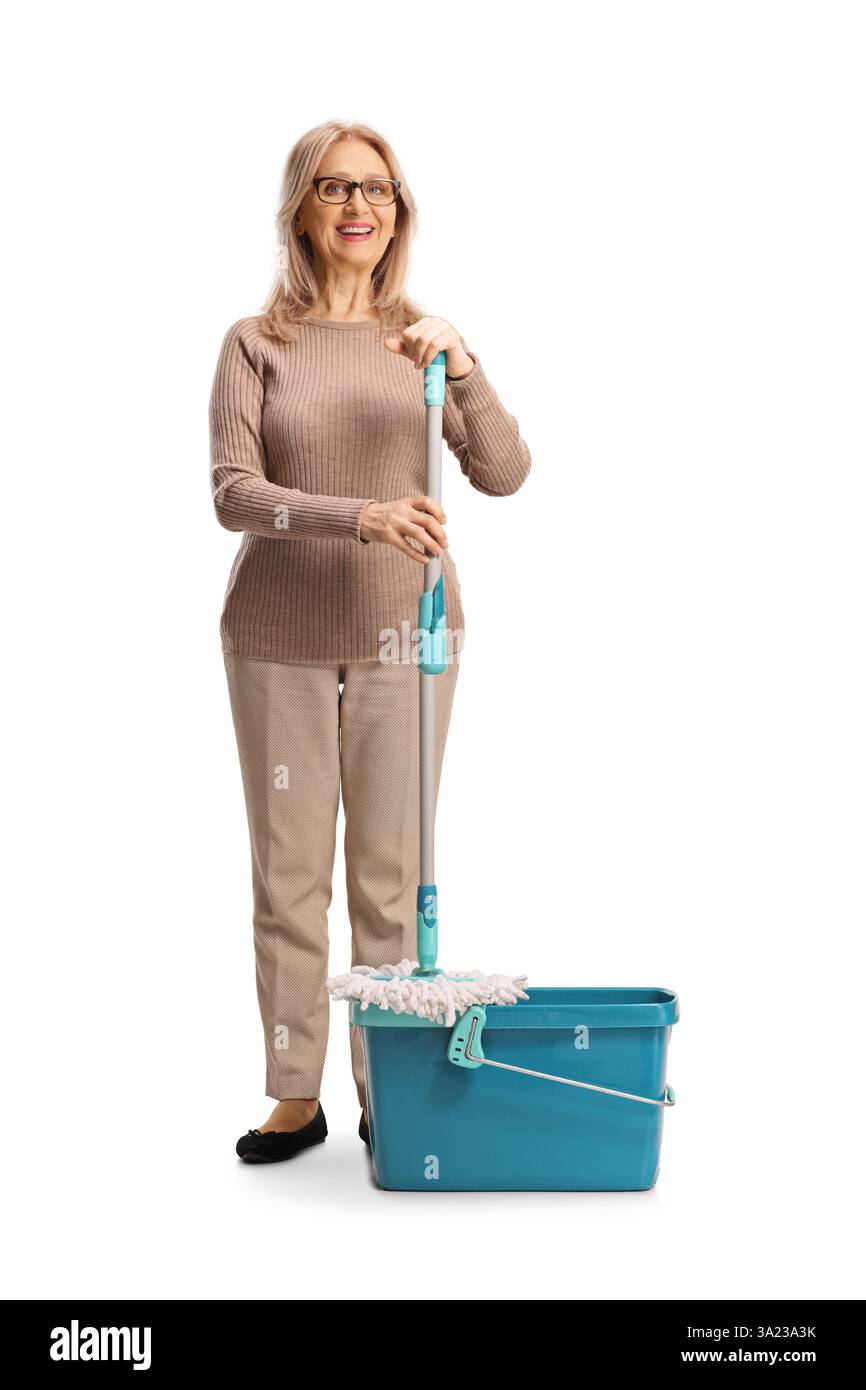 Woman with a bucket and mop smiling at camera isolated on white ...