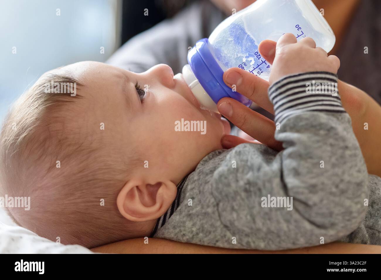 Baby boy drinking milk Stock Photo - Alamy