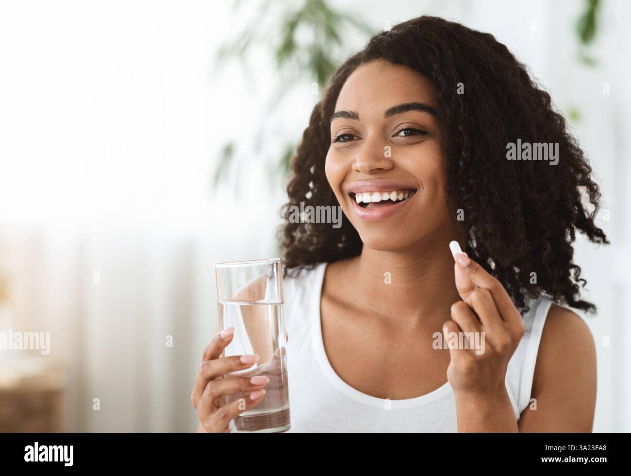 Healthy Diet Nutrition. Smiling Afro Woman Holding Vitamin Pill And Mineral Water Stock Photo ...