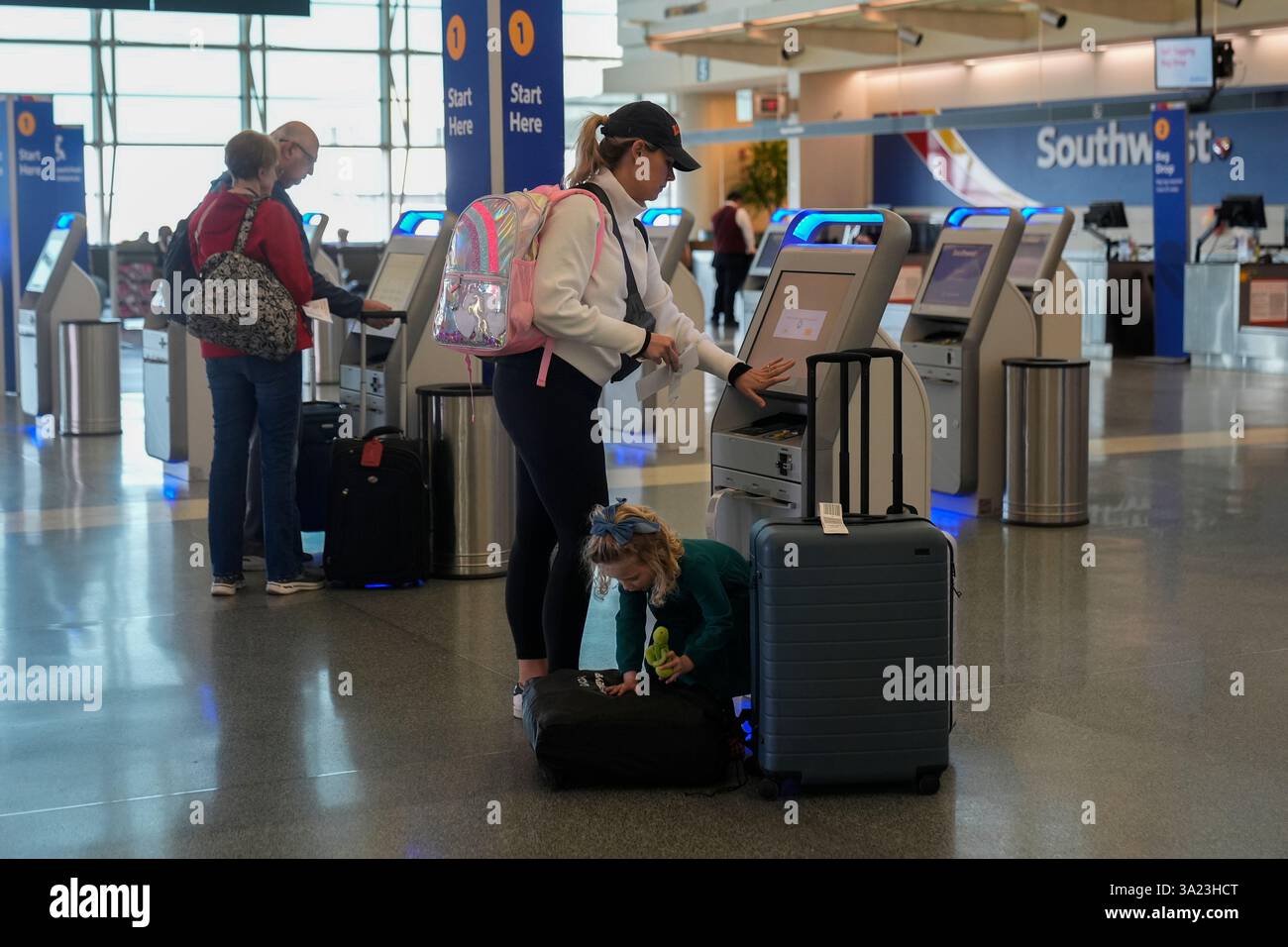 Travelers use Southwest Airlines kioks to check bags at Midway ...