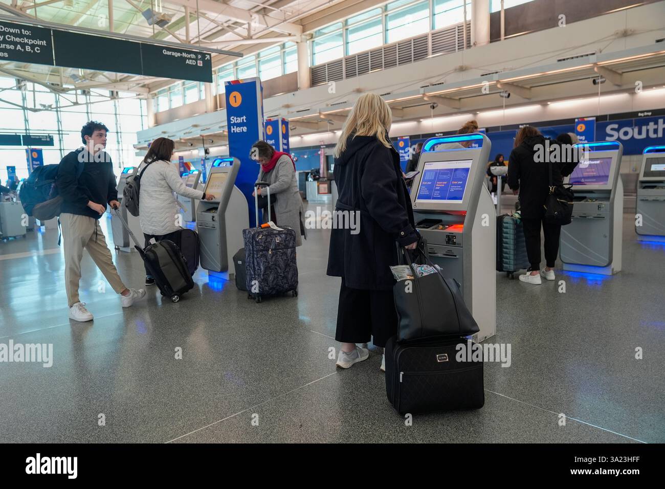 Travelers use Southwest Airlines kioks to check bags at Midway ...