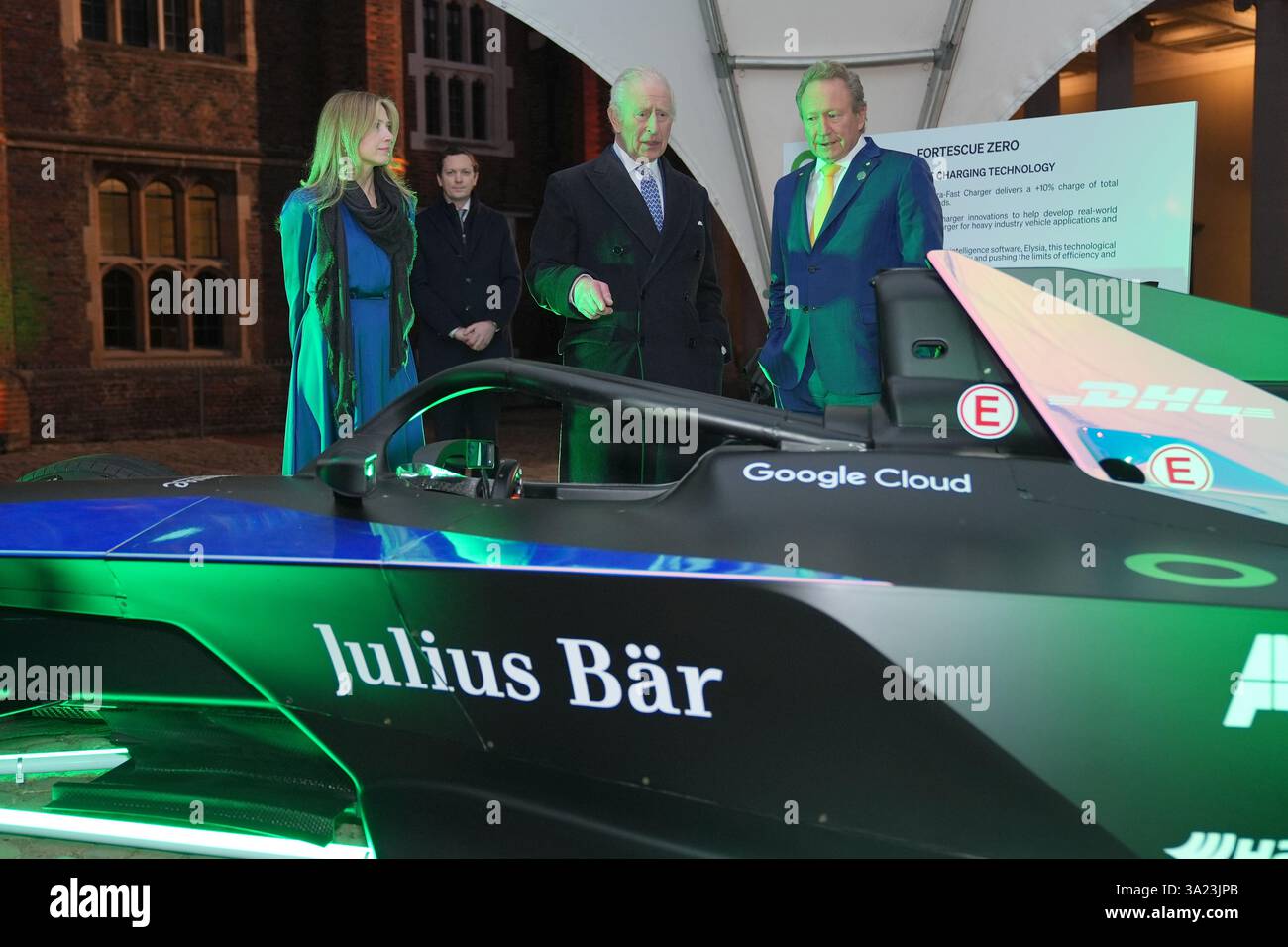 King Charles III looking at a Formula E car with SMI chief executive ...