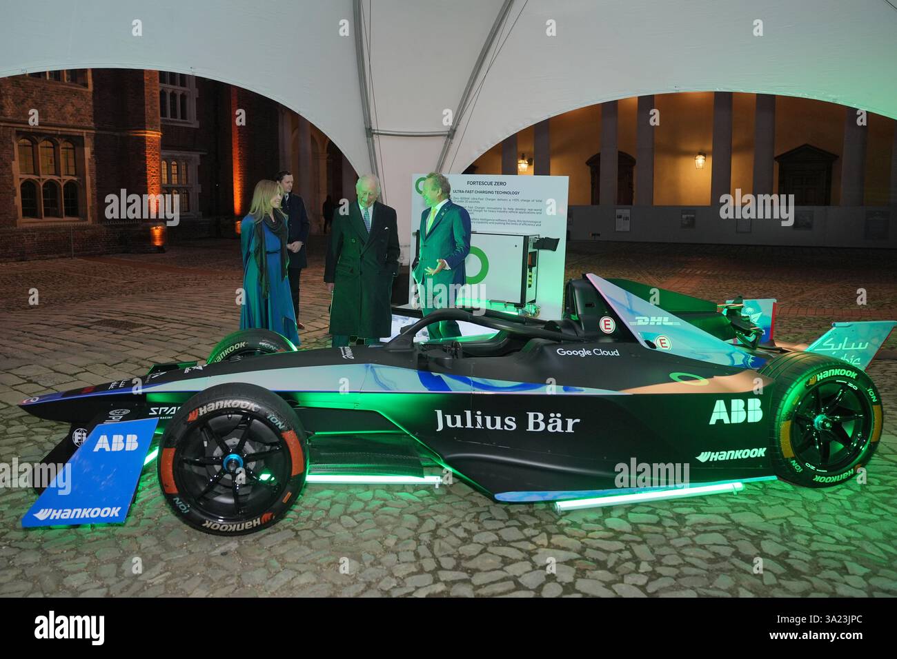 King Charles III looking at a Formula E car with SMI chief executive ...