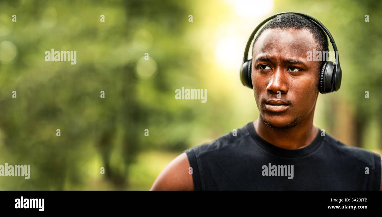 Portrait of concentrated black guy with wireless headset, training ...