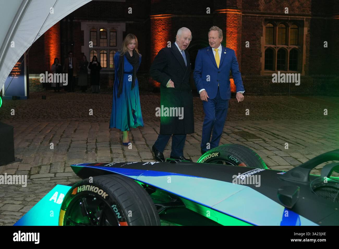 King Charles III looking at a Formula E car with SMI chief executive ...