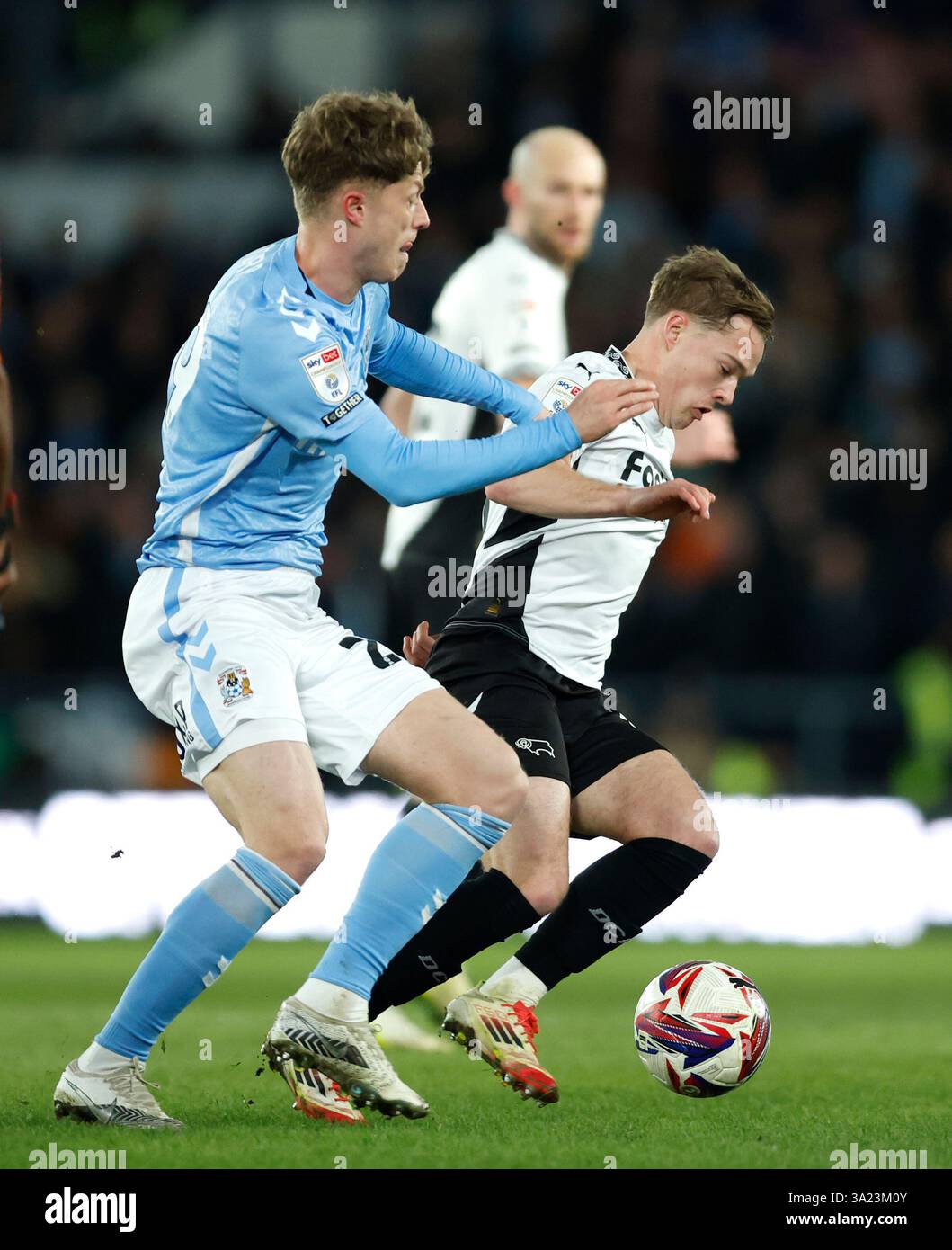 Coventry City's Victor Torp and Derby County's Liam Thompson battle for ...