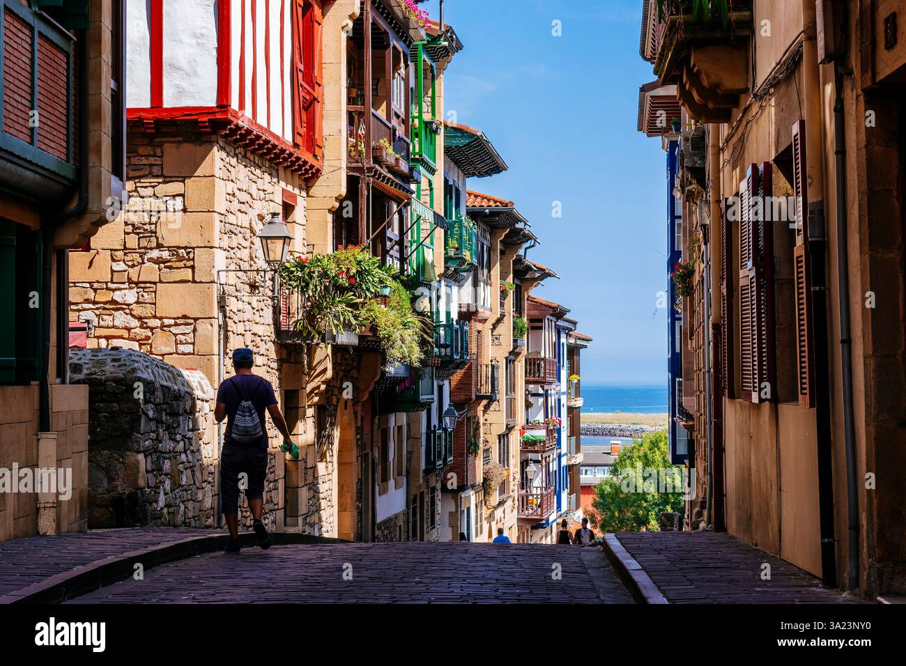 Typical street of the village. Houses with colorful balconies ...