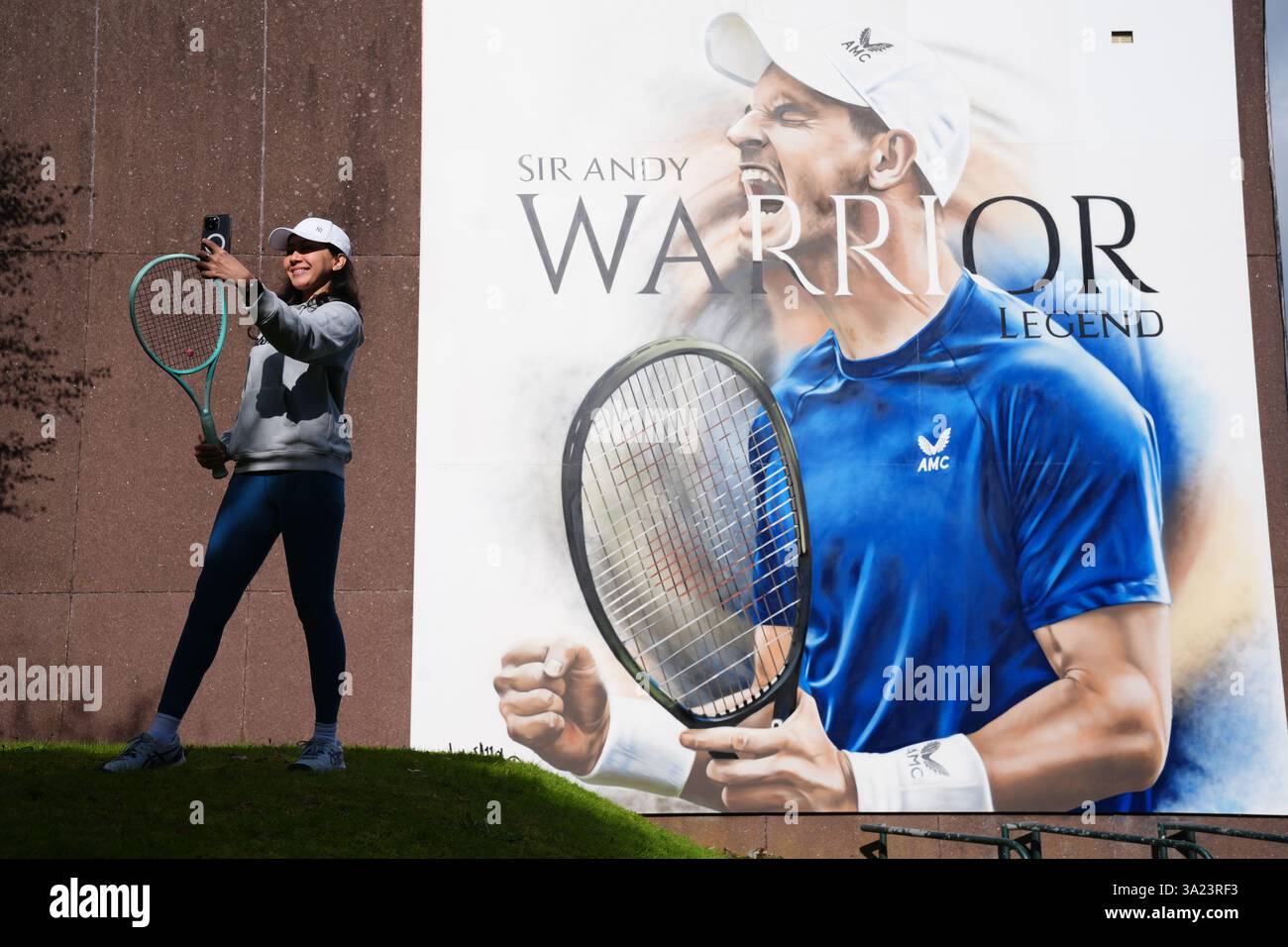 Club member Indriana Arifin takes a selfie with the 20ft artwork ...