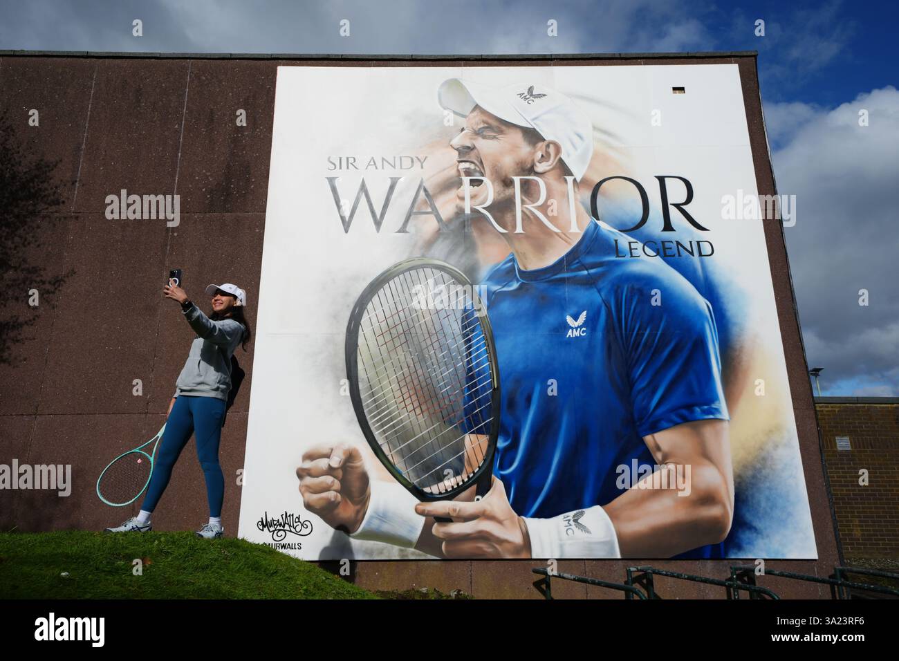Club member Indriana Arifin takes a selfie with the 20ft artwork ...
