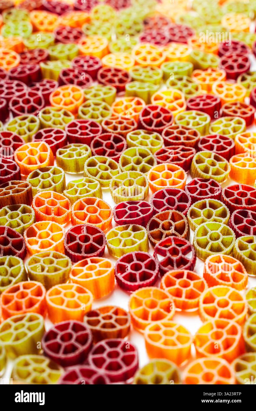 Background with texture dry italian pasta Rotelle. Different flavors ...