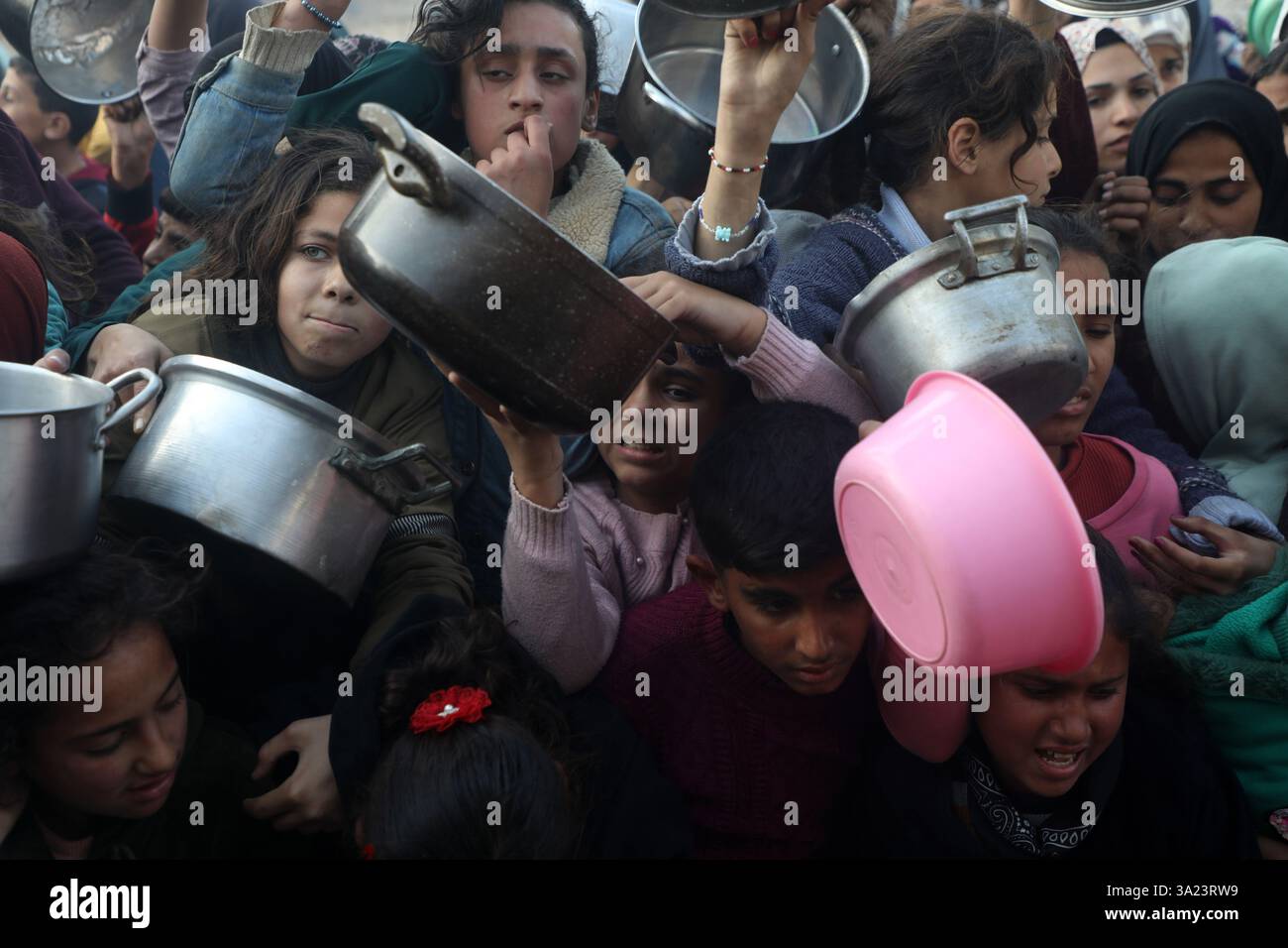 (250311) -- JABALIA, March 11, 2025 (Xinhua) -- People try to get food ...