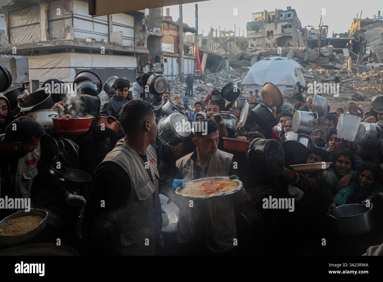 Jabalia, Gaza Strip. 11th Mar, 2025. People wait in front of a charity ...