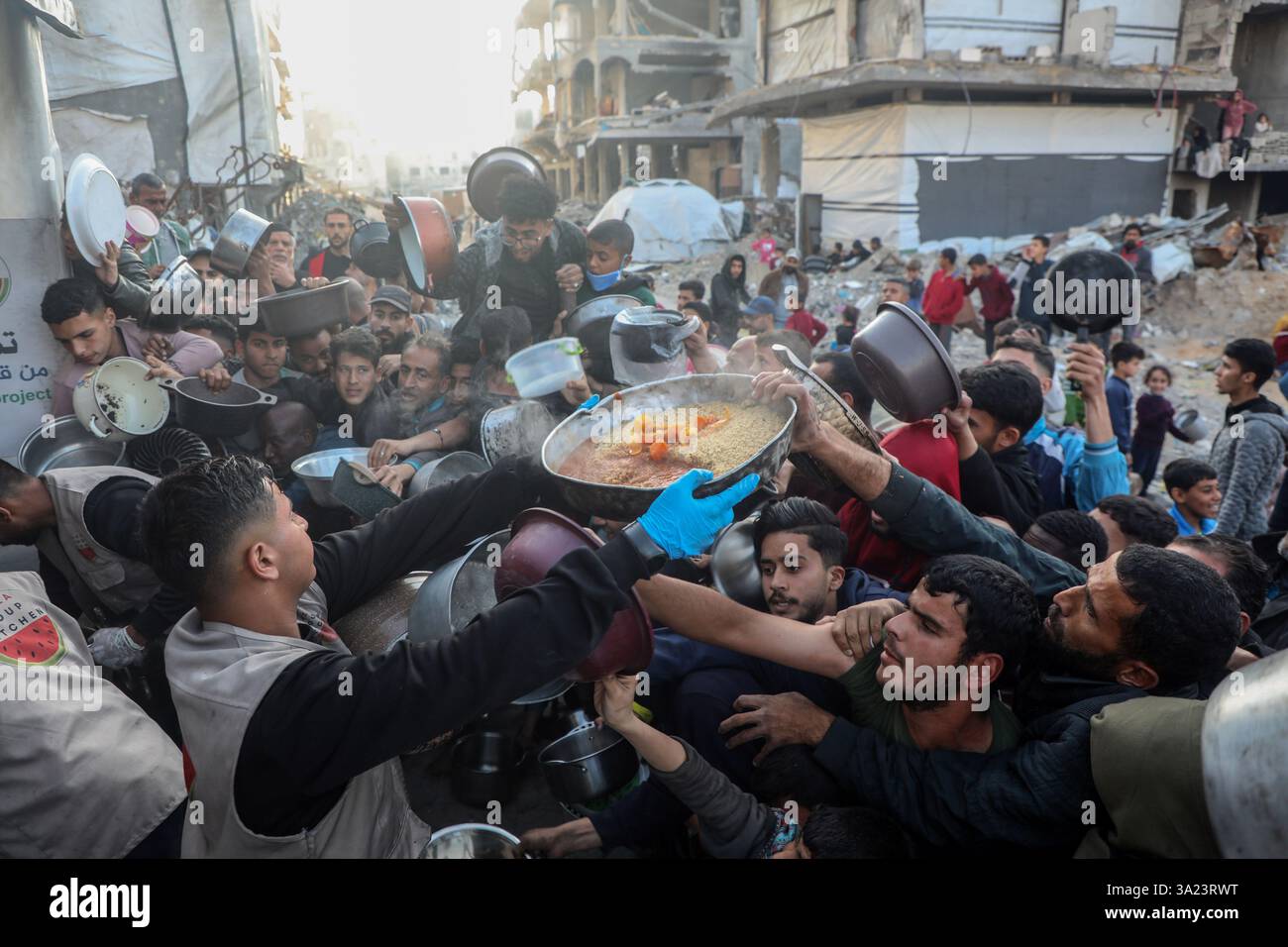 Jabalia, Gaza Strip. 11th Mar, 2025. People try to get food at a ...