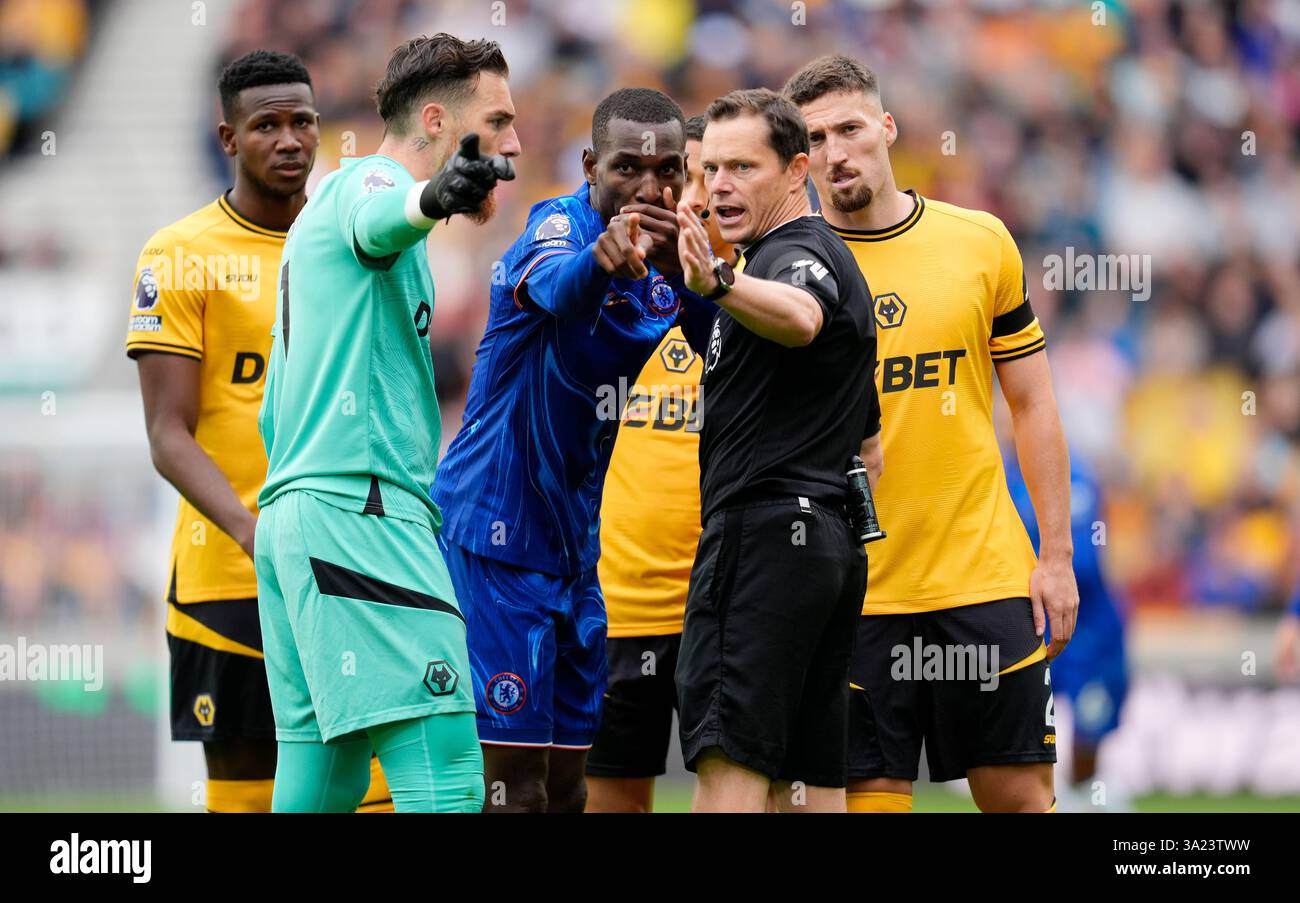 Players from both teams alert referee Darren England to something off ...