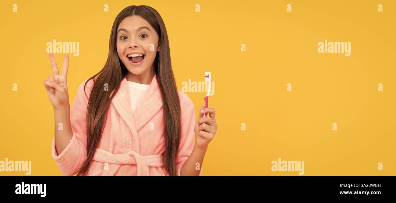 happy amazed teen girl in home terry bathrobe hold toothbrush show ...